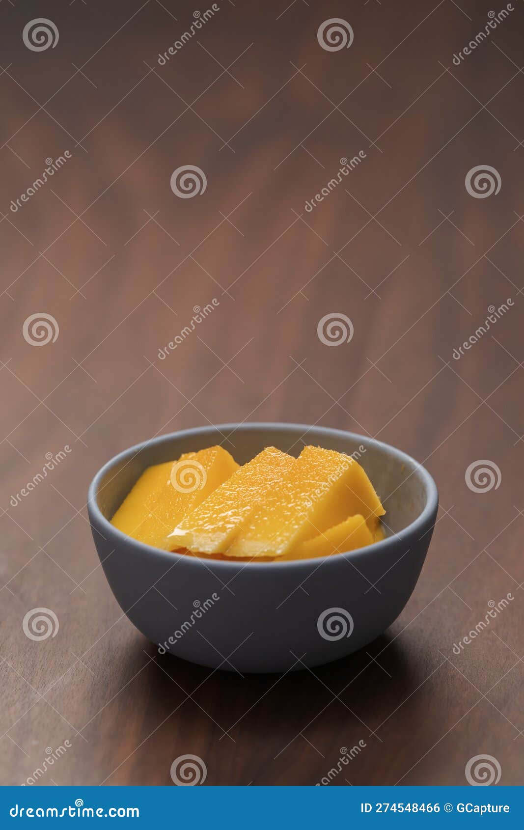 Fresh Sliced Mango in a Ceramic Bowl on Walnut Table Stock Photo ...