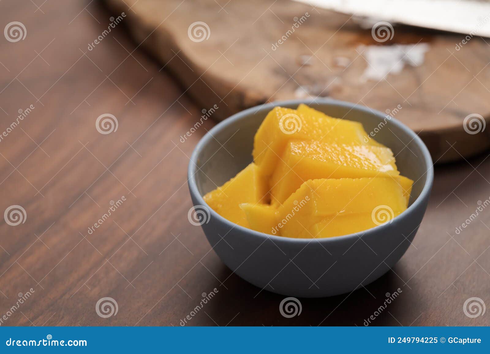 Fresh Sliced Mango in a Ceramic Bowl on Walnut Table Stock Image ...