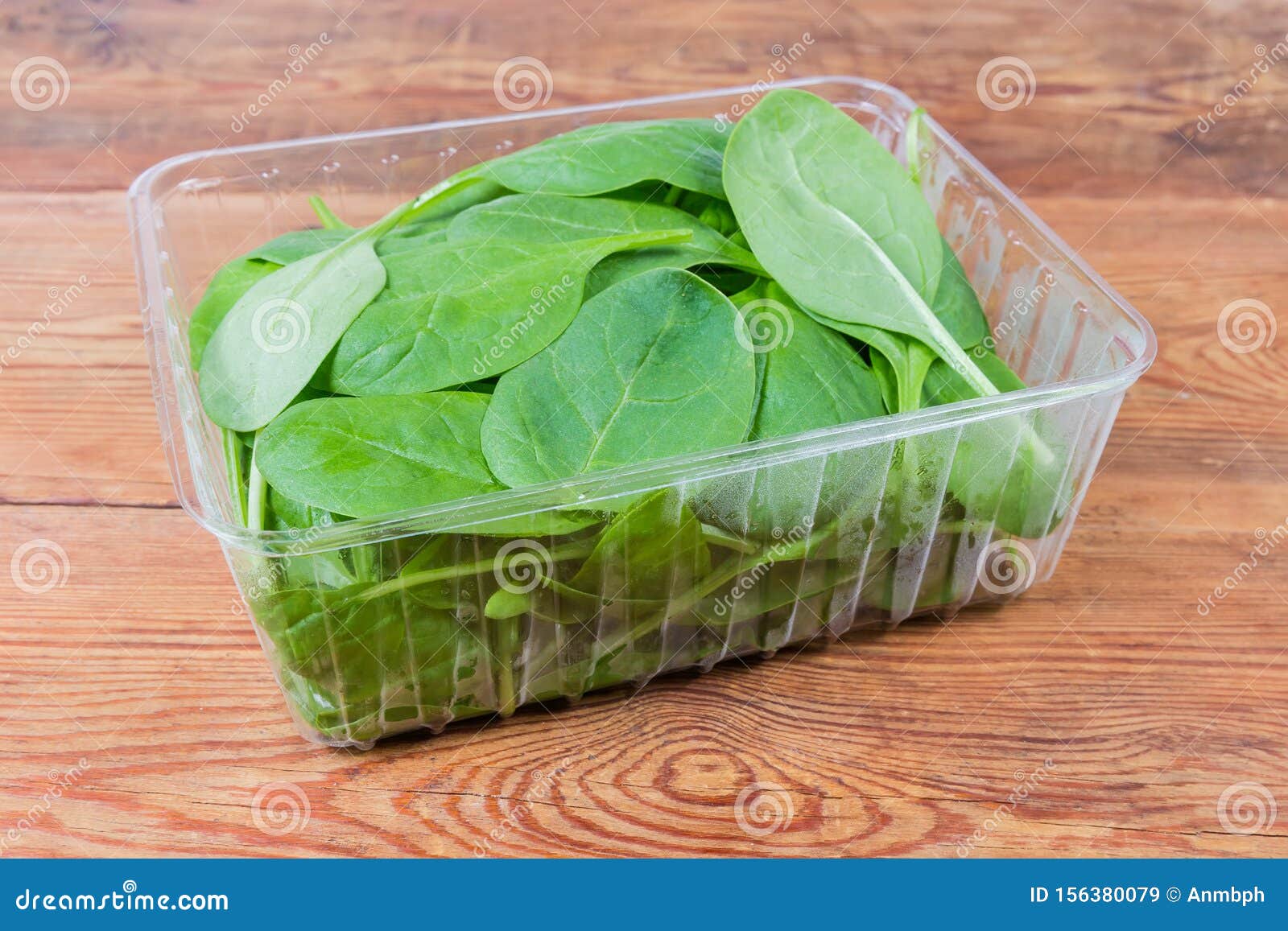 Fresh Spinach Leaves in Plastic Container on Rustic Table Stock Image ...