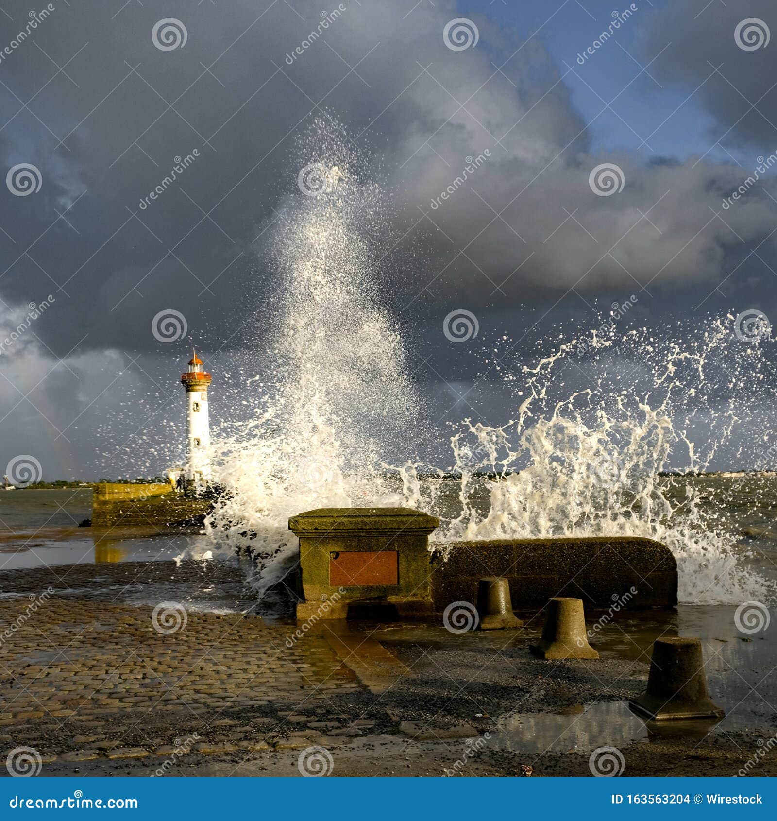 Fresh Splash of Water Next To a Lighthouse Under the Gloomy Sky Stock ...