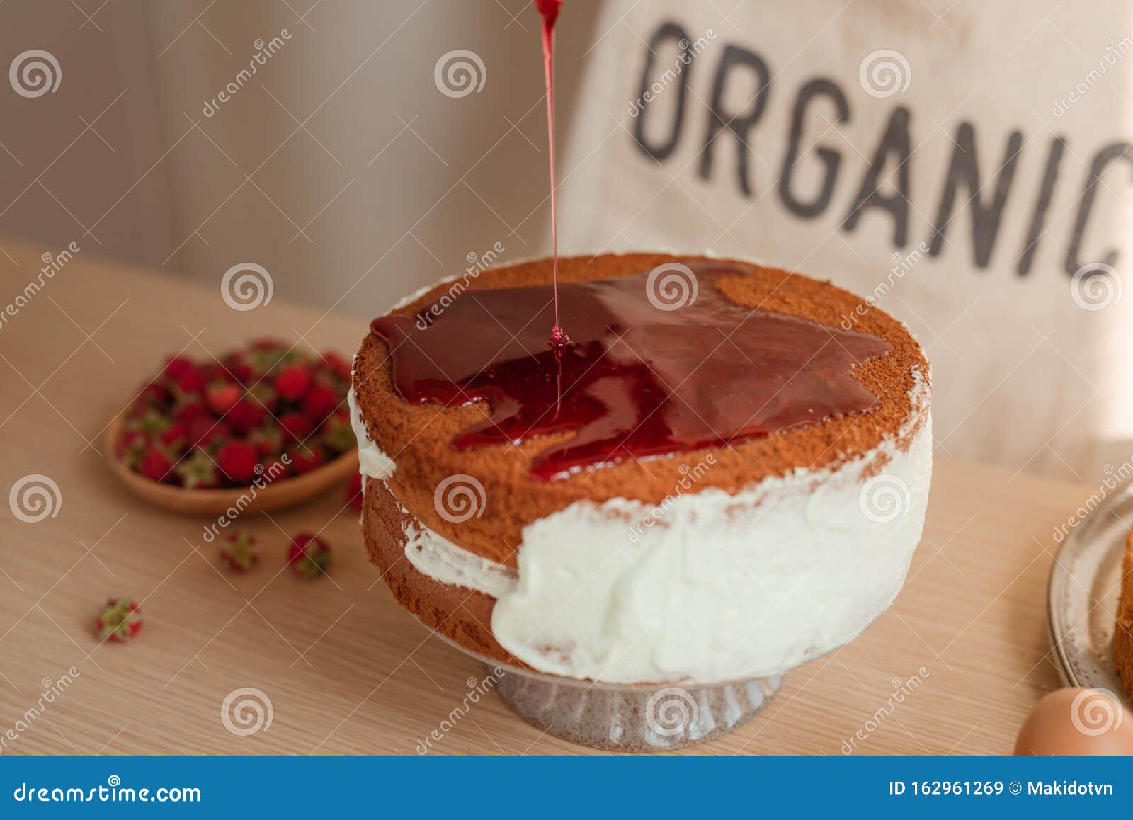 Fresh Sponge Cake with Raspberry Syrup Being Poured Over the Top ...