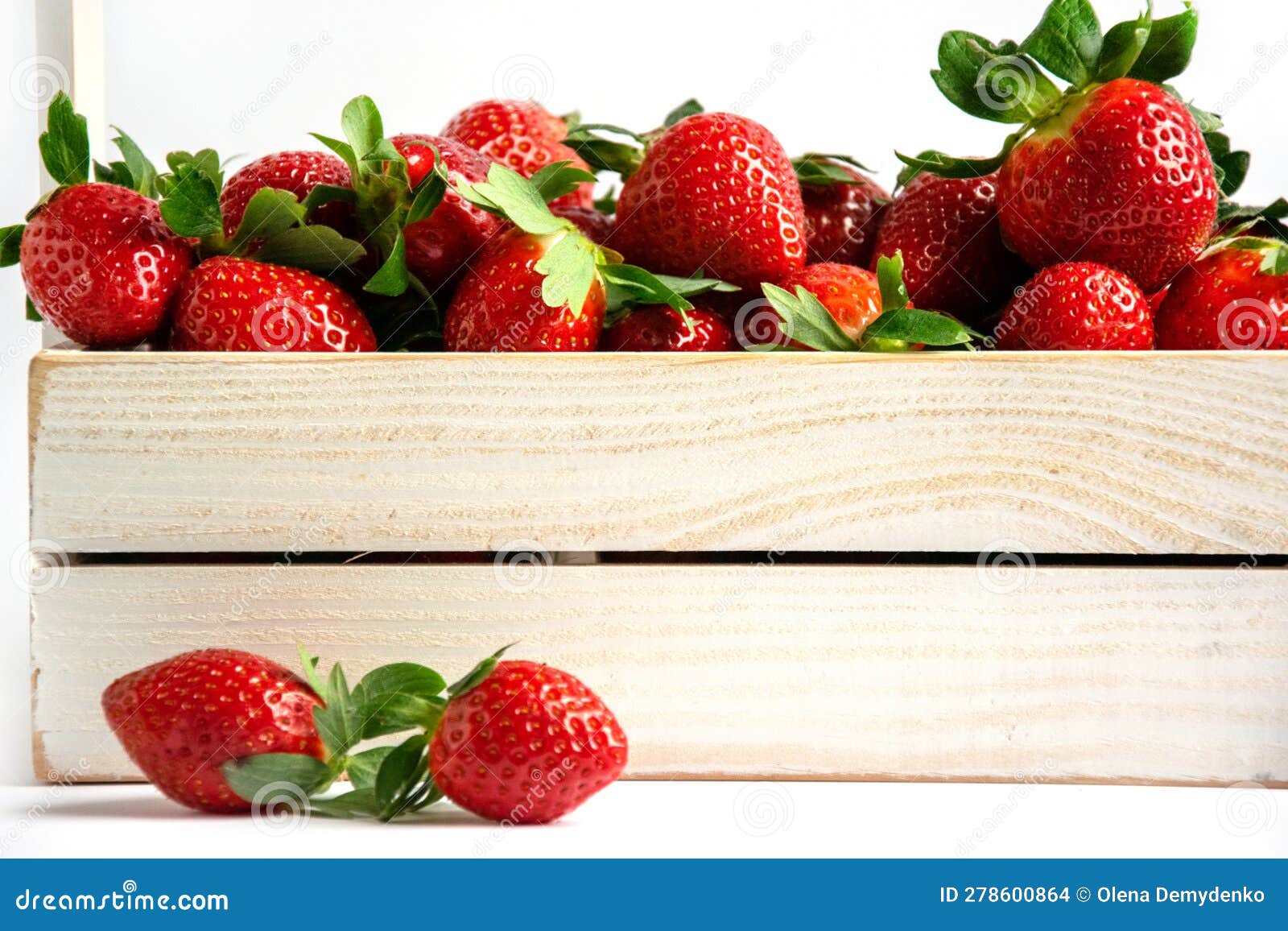 Fresh Strawberries Close-up in a Wooden Box on a White Background ... Fresh Strawberries Close-up in a Wooden Box on a White Background ...