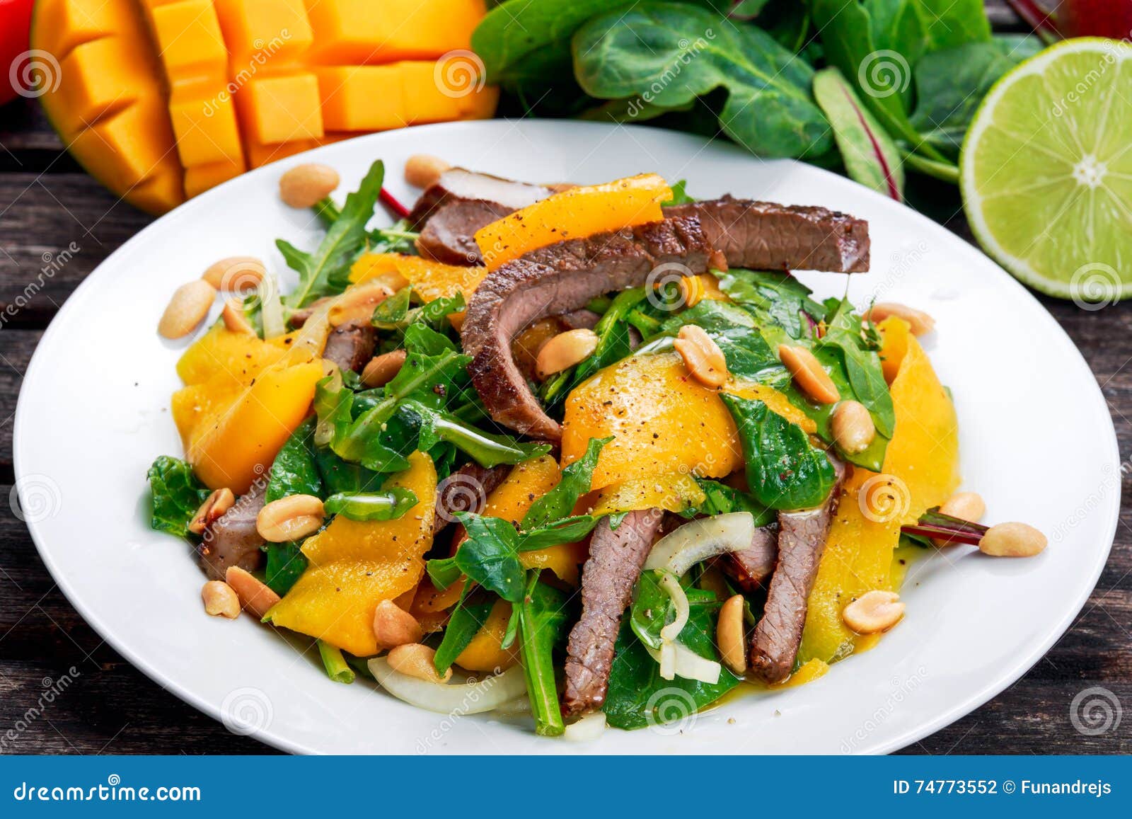 Fresh Tasty Mango, Beef Salad with Vegetables and Nuts. on Wooden Table ...