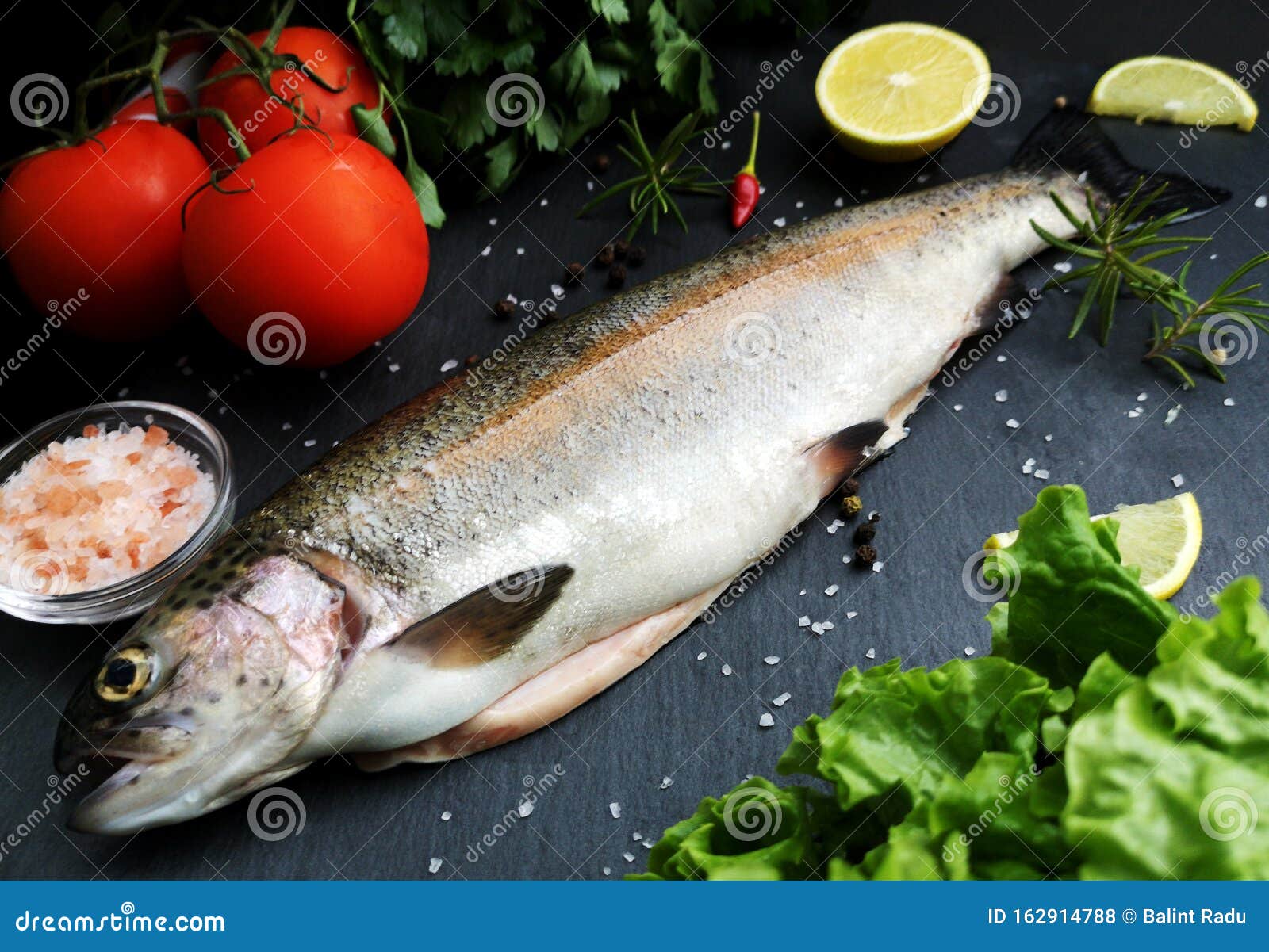 Fresh Trout with Vegetables on a Dark Table Stock Photo - Image of ...