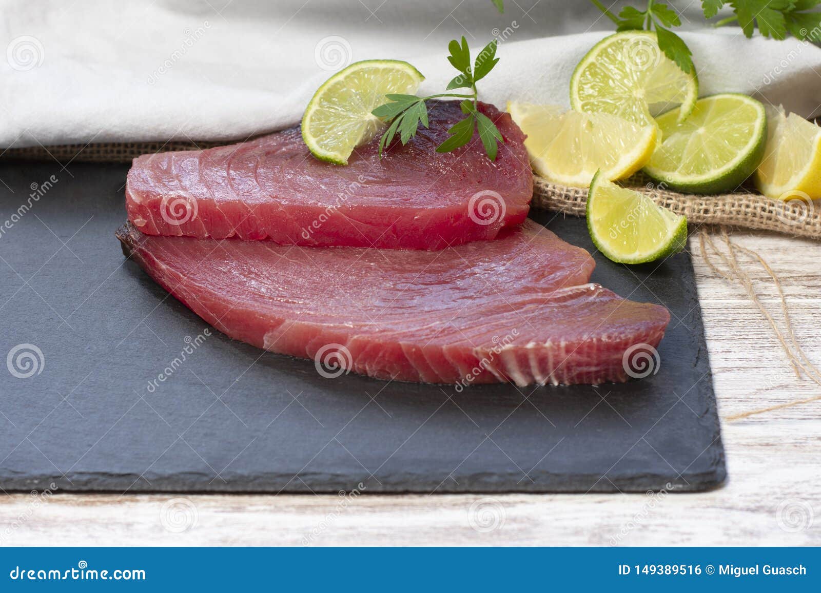 Fresh Tuna Fillets Accompanied by Citrus and on Black Stone - Image ...