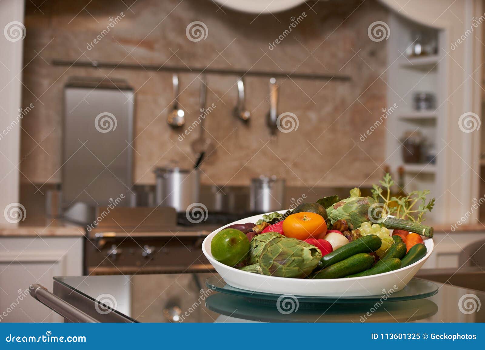 Fresh Vegetables on Table Over Blurred Modern Kitchen Counter Stock ...
