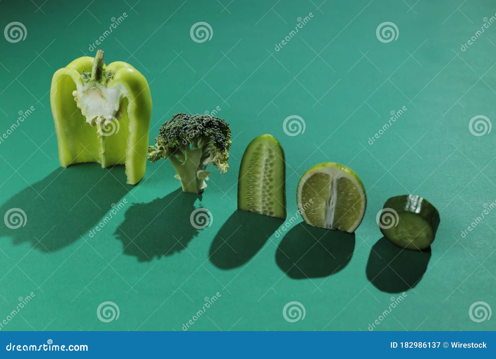 Fresh Vegetables and Their Shadows Isolated on a Green Surface Stock ...