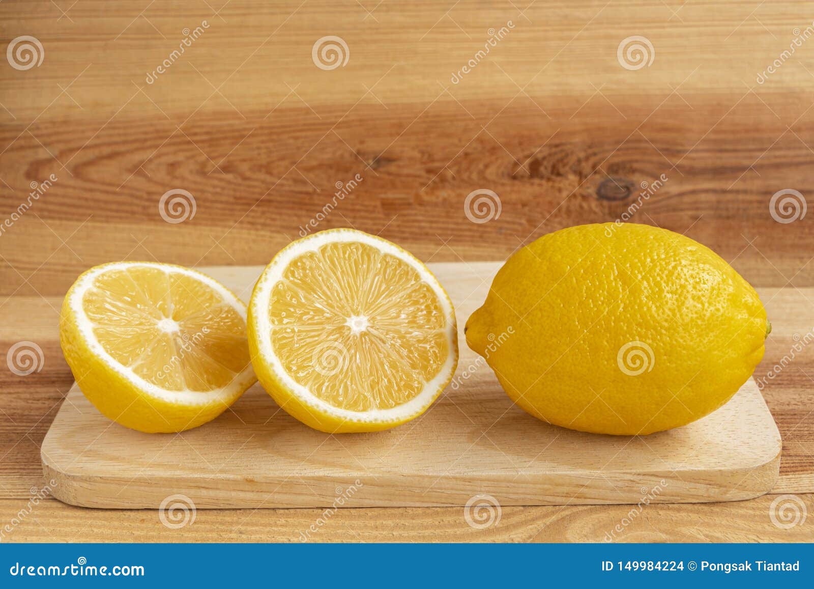Fresh Yellow Lemon and Half a Lemon on a Wooden Table Stock Photo ...