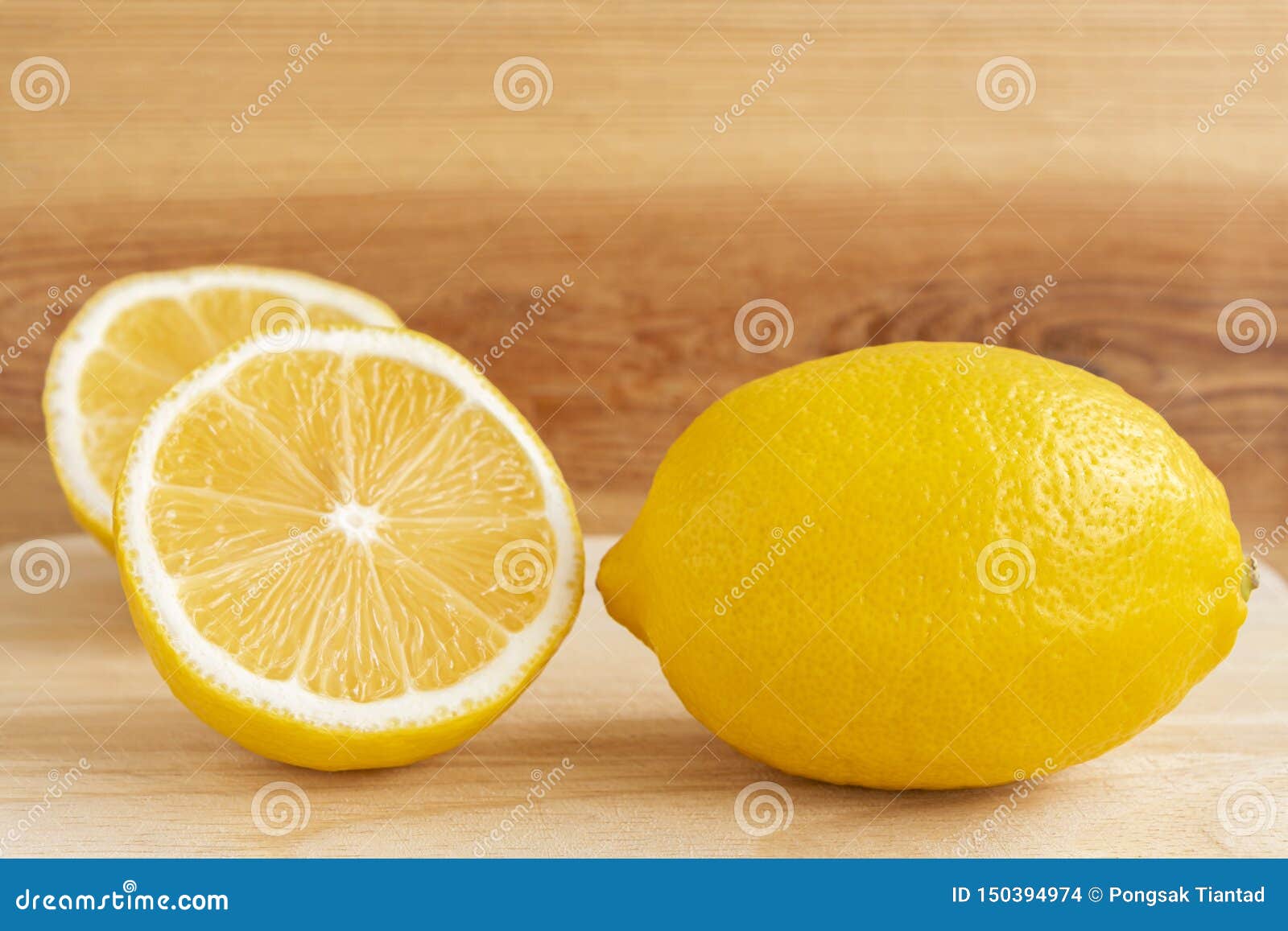 Fresh Yellow Lemon and Half a Lemon on a Wooden Table Stock Photo ...
