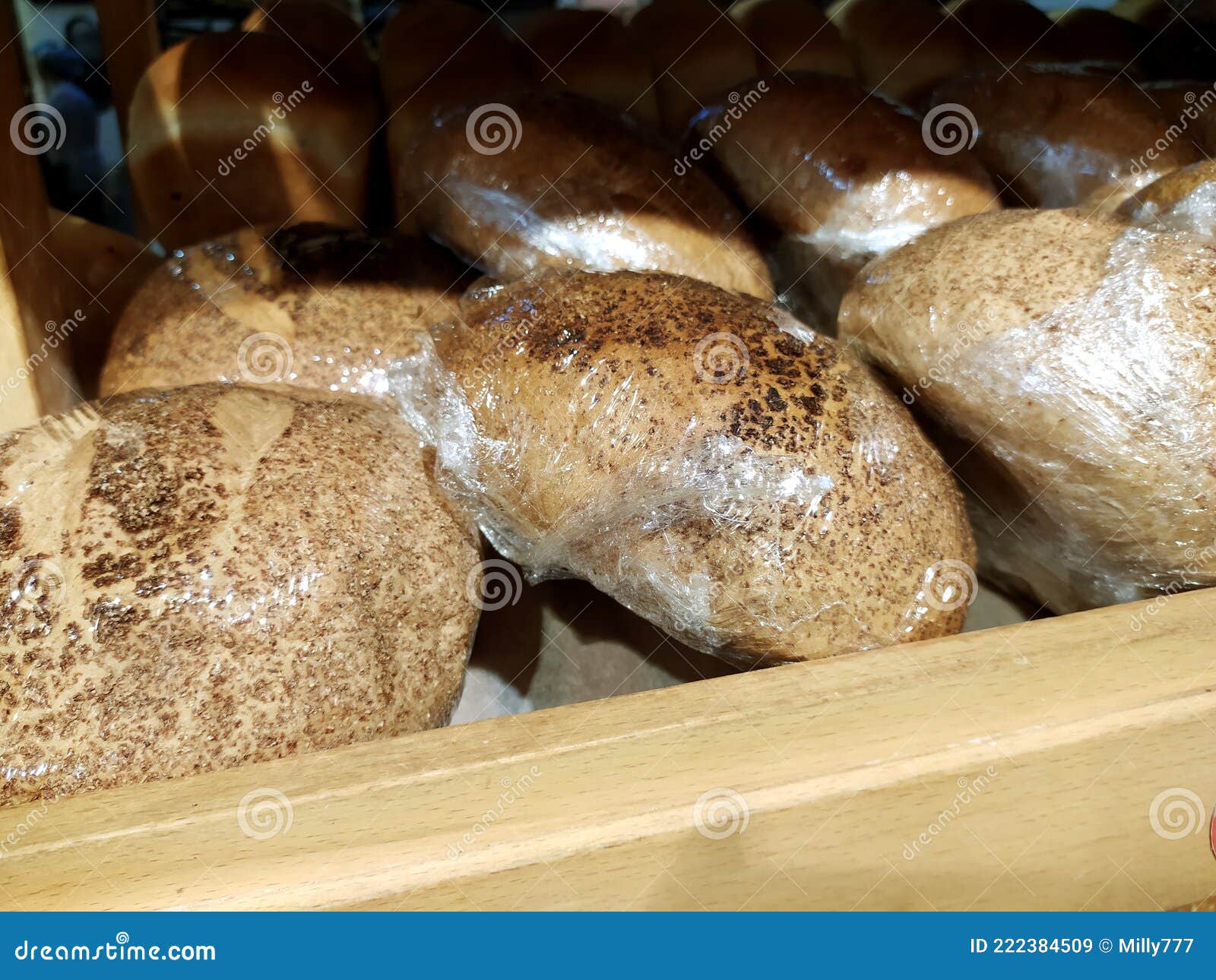 Freshly Baked Bread Wrapped in Plastic Wrap Lies on a Store Shelf Stock ...