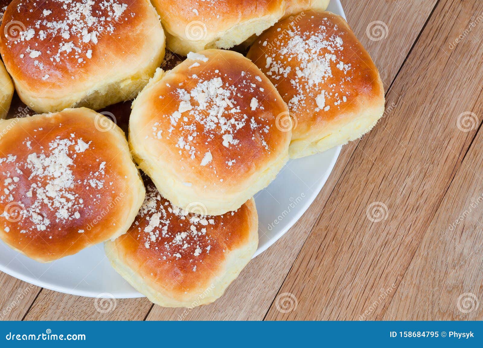 Freshly Baked Buns on a Plate on a Wooden Table Stock Image - Image of ...