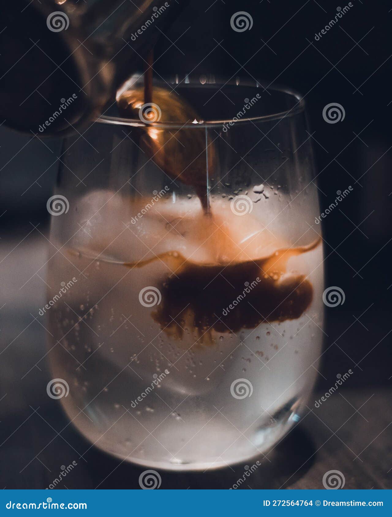 Freshly Brewed Coffee Pouring into a Glass Cup of Ice Water Stock Photo ...