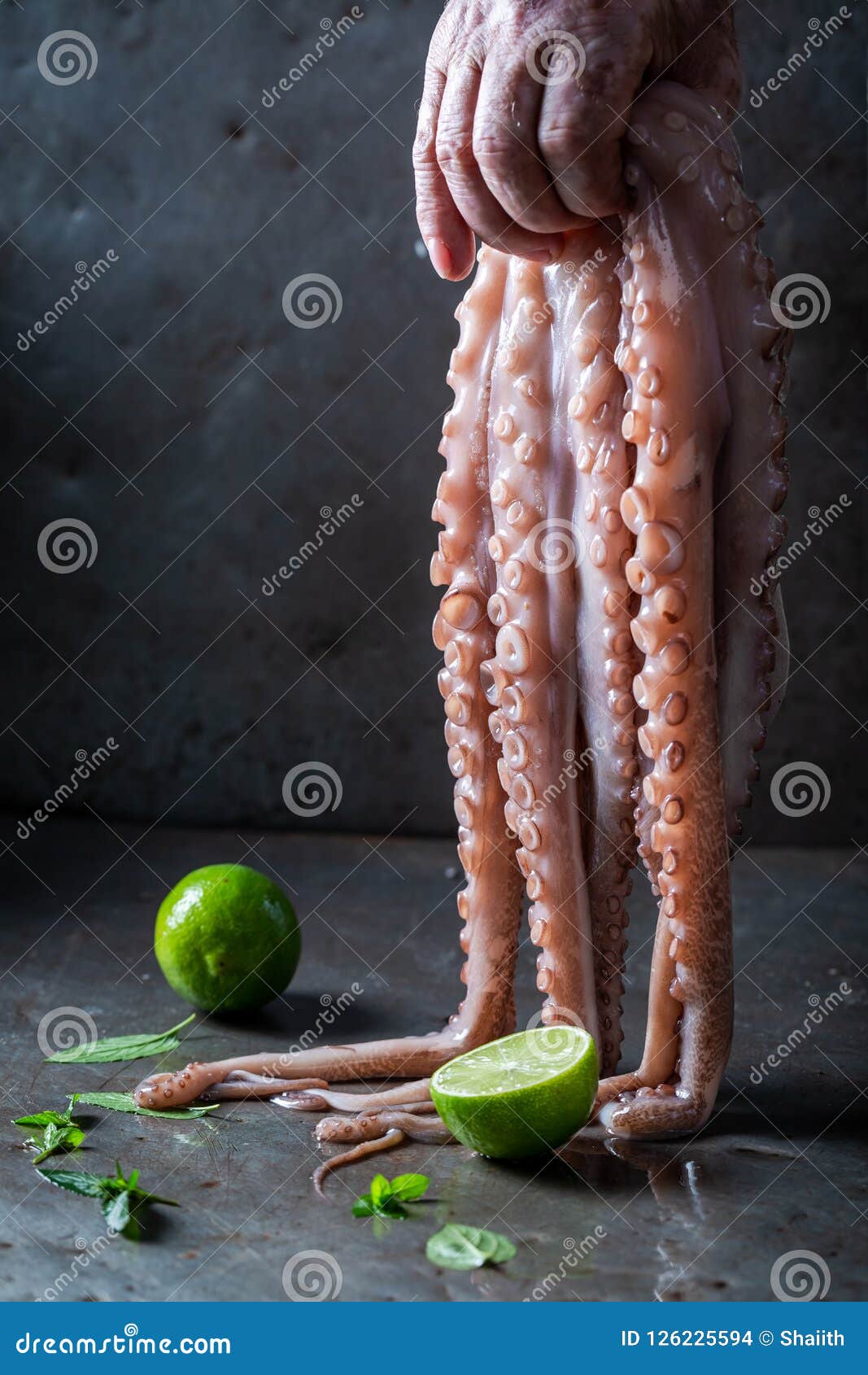 Freshly Caught Octopus Holding in Hand and Lime Stock Photo - Image of ...