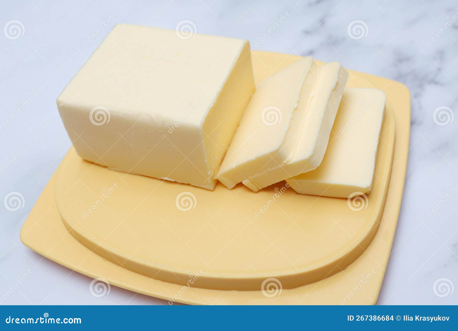 Freshly Cut Butter on a Yellow Plate. Butter Pieces. Stock Photo ...