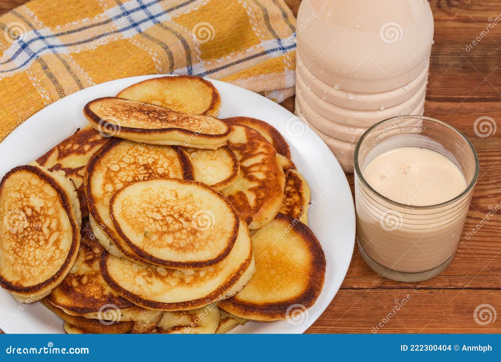 Freshly Fried Oladyi on Dish, Fermented Milk on Rustic Table Stock ...