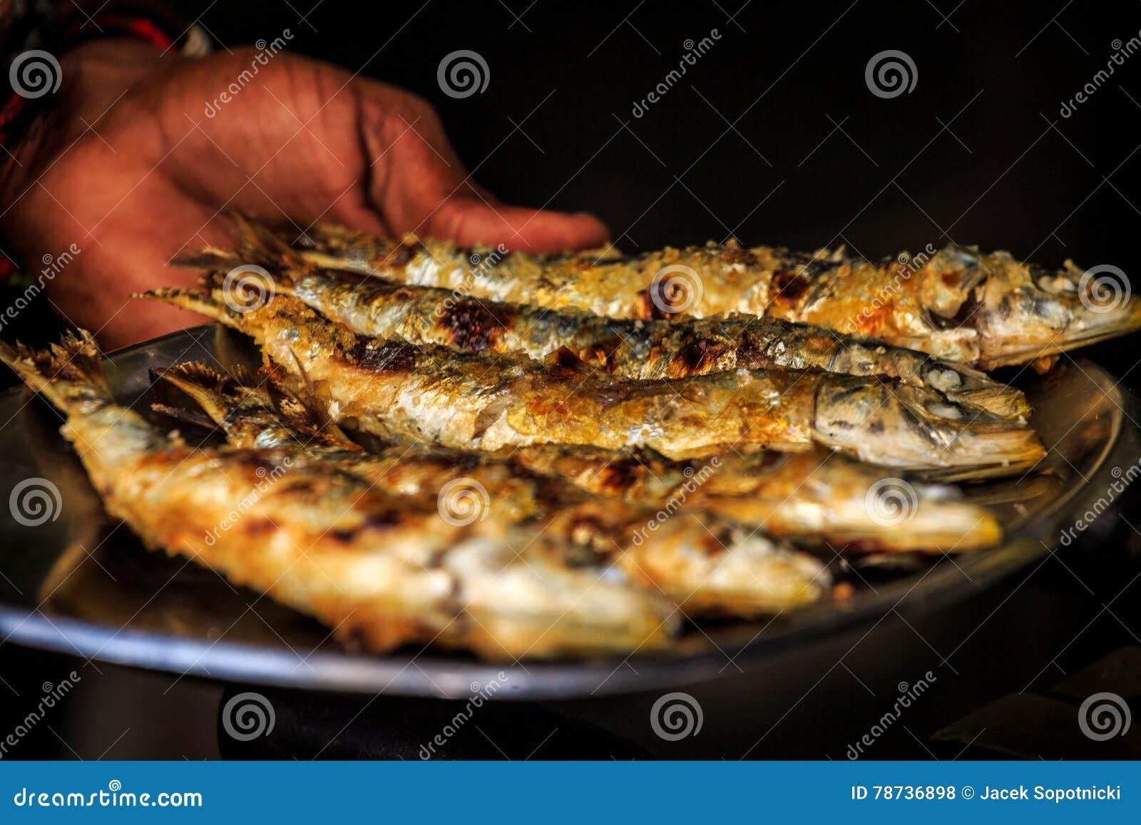Freshly Grilled Sardines on Silver Plate Stock Photo - Image of hand ...