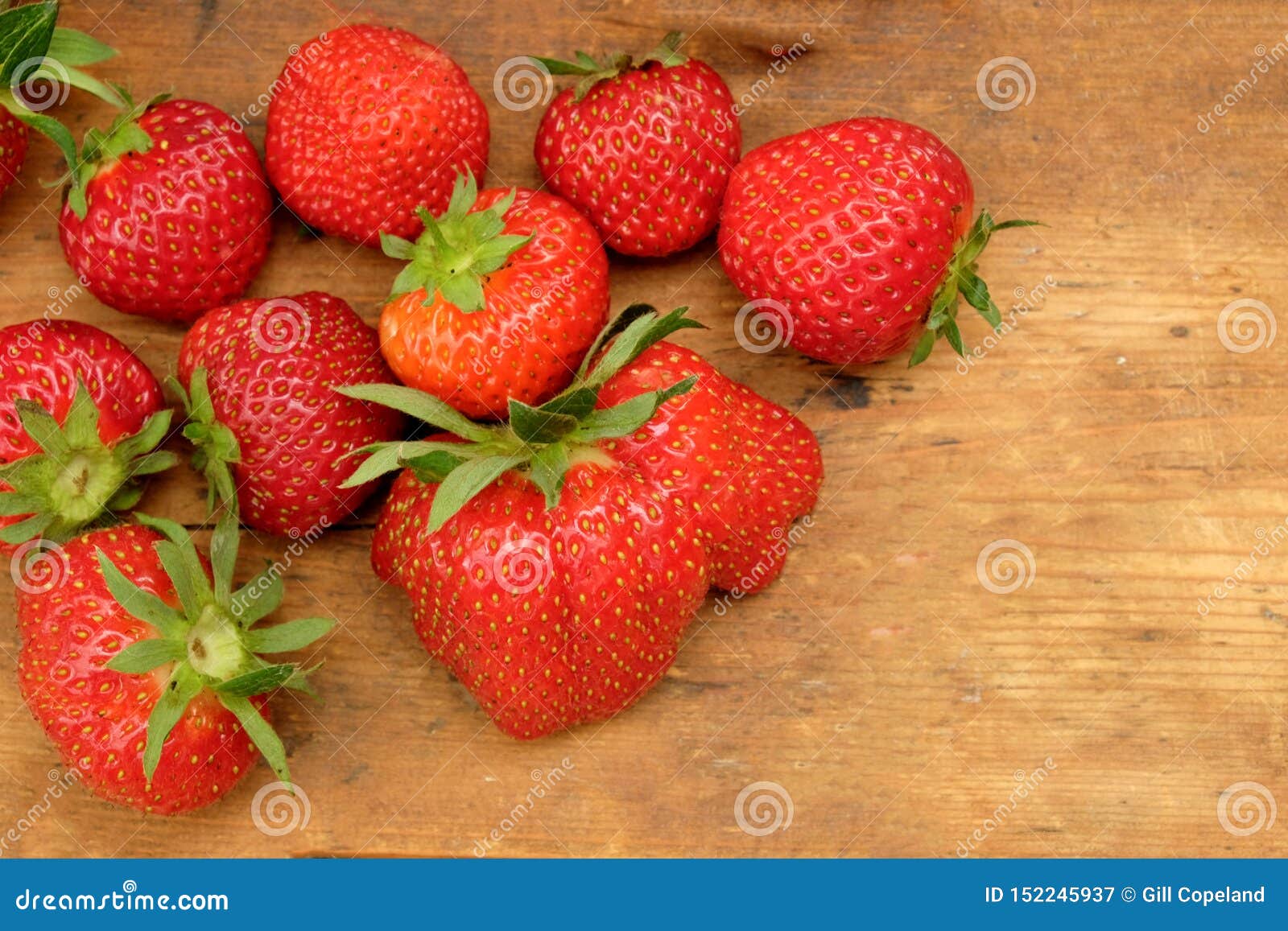 Freshly Picked Strawberries on a Rustic Wooden Table Top Stock Image ...