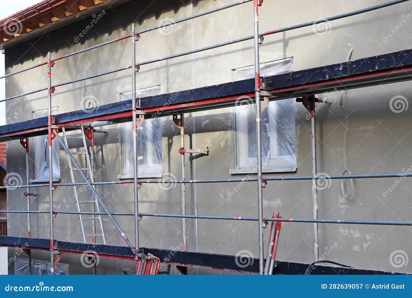 A Freshly Plastered New Building with Scaffolding and Taped Windows ...