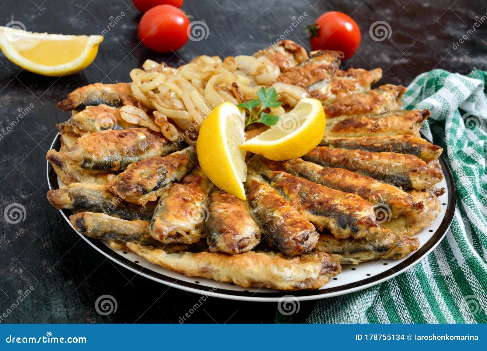 Fried Capelin, Sprats. Small Fried Fish on a Plate on a Black ...