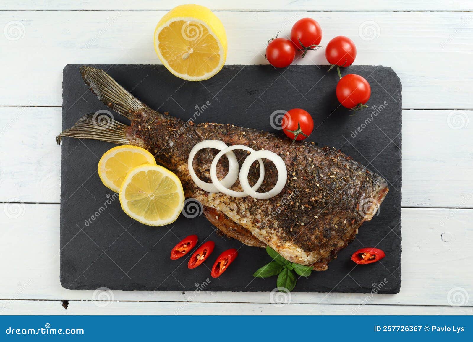 Fried Carp Fish on the Table. Baked Fish with Vegetables Stock Image ...