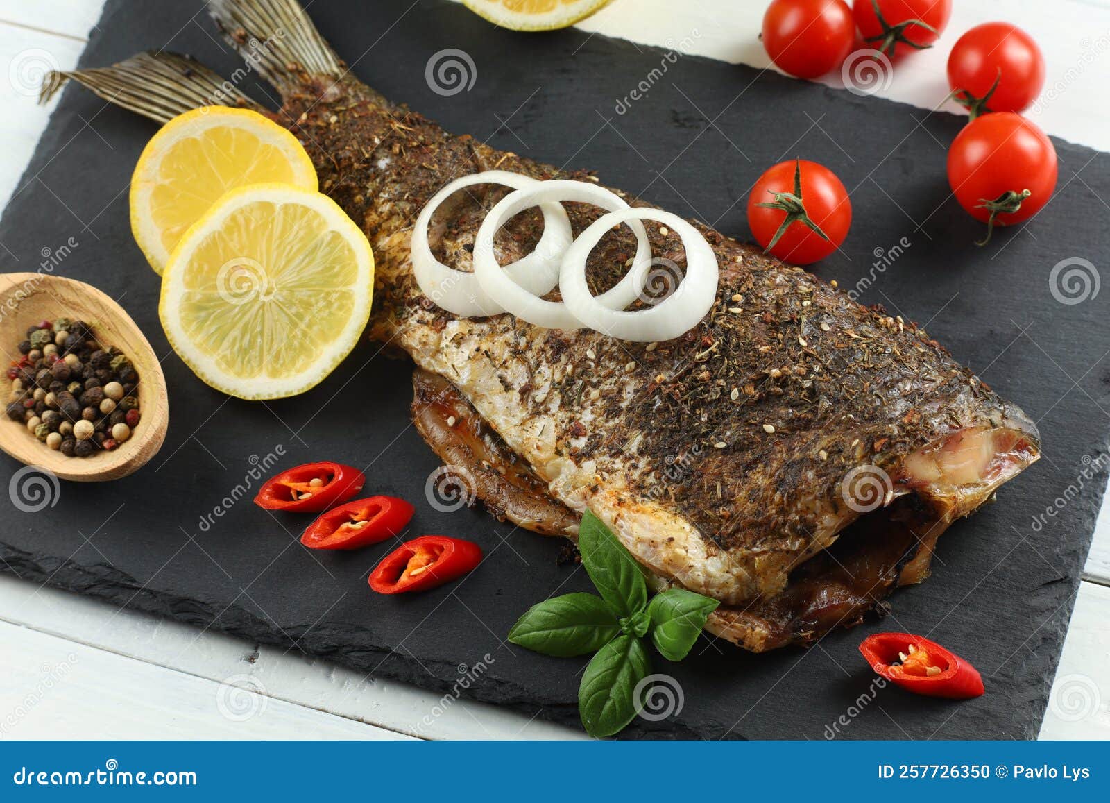 Fried Carp Fish with Vegetables, Tomatoes and Lemon. Fish Baked with ...