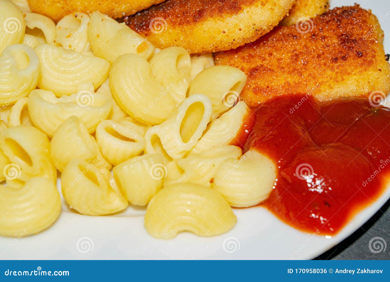 Fried Chicken Nuggets and Boiled Pasta with Ketchup on a Plate. Close ...