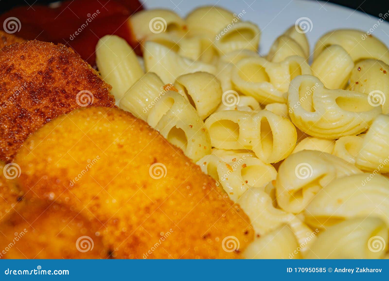 Fried Chicken Nuggets and Cooked Pasta on a Plate. Close Up Stock Image ...