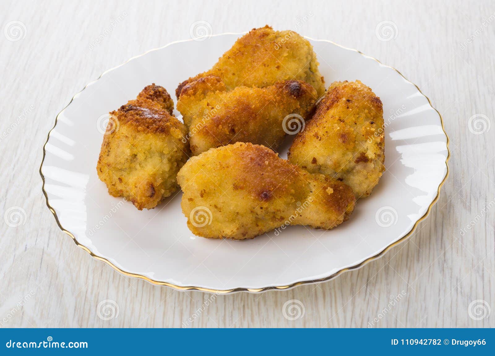 Fried Chicken Winglets in Breading in Plate on Table Stock Photo ...