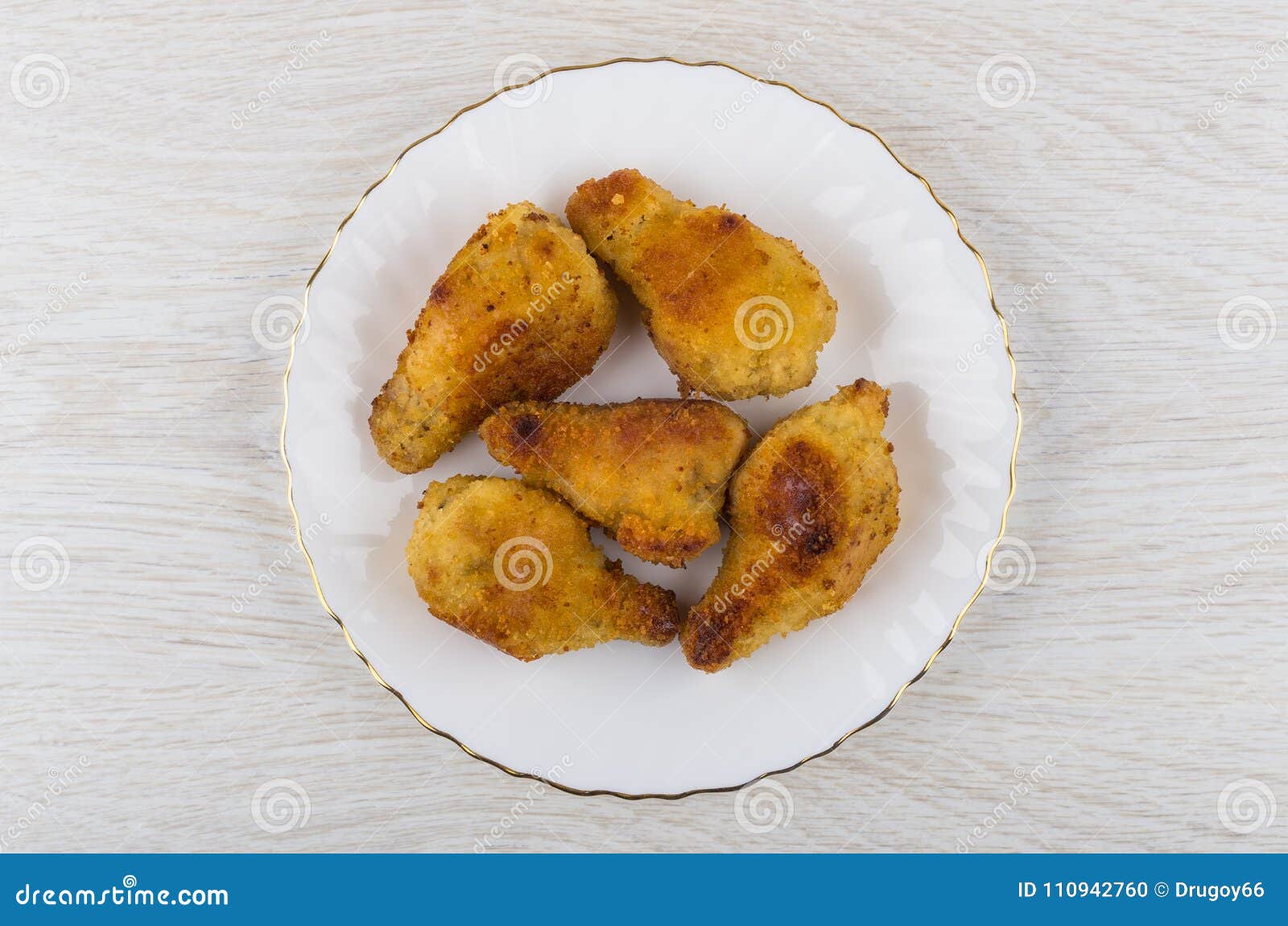 Fried Chicken Winglets in Breading in Plate on Wooden Table Stock Photo ...