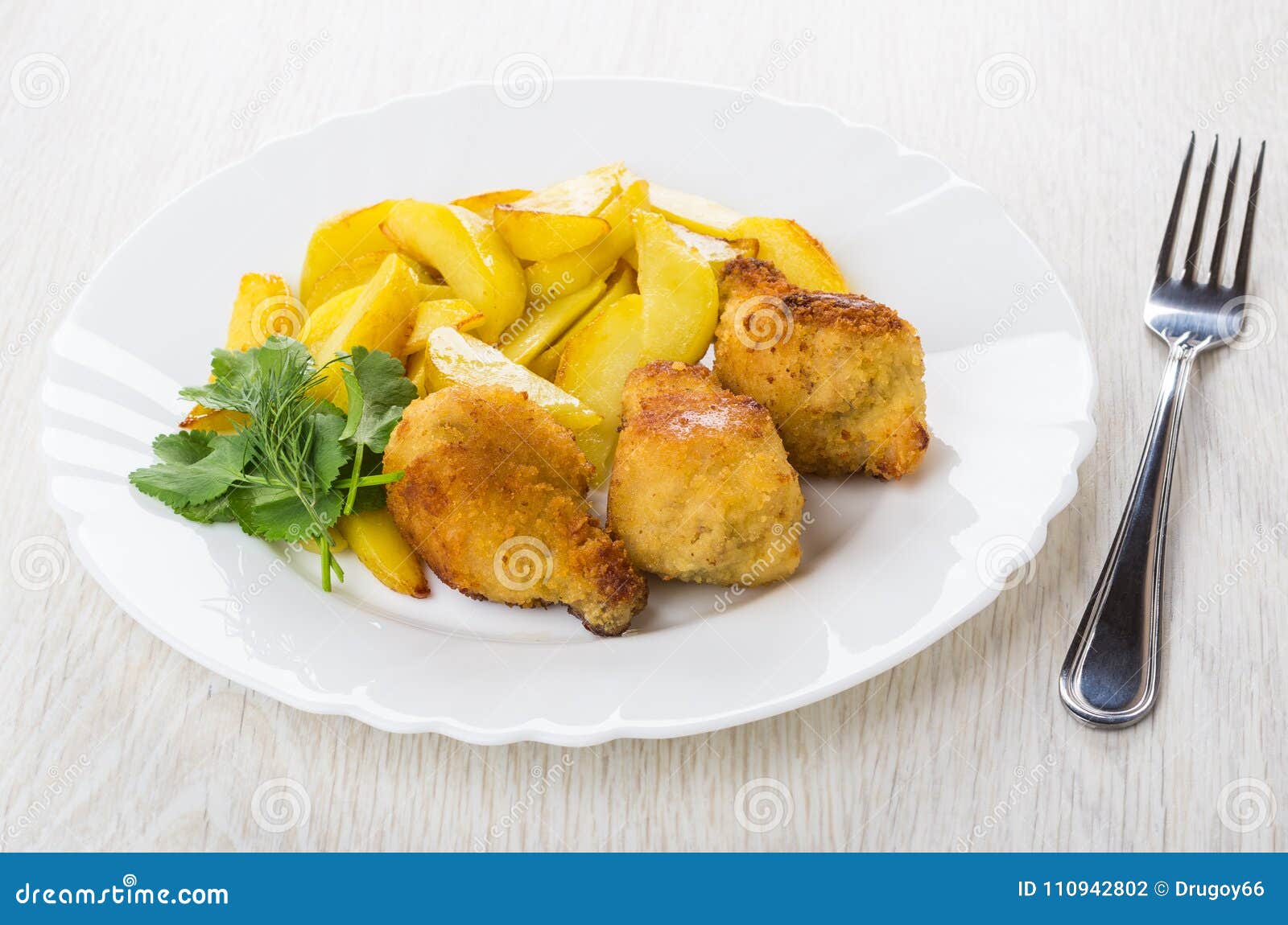 Fried Chicken Winglets in Breading with Potato in Plate, Fork Stock ...