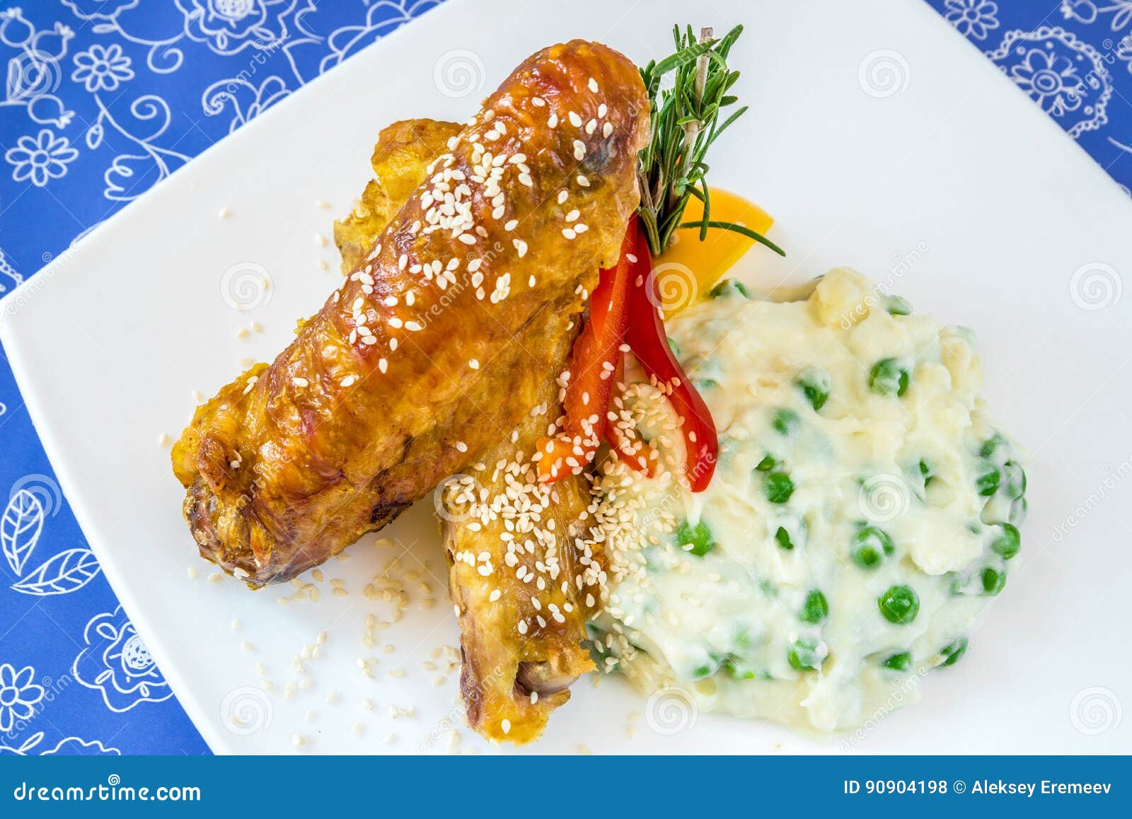 Fried Chicken Wings with Mashed Potatoes, Peas and Herbs Stock Photo ...