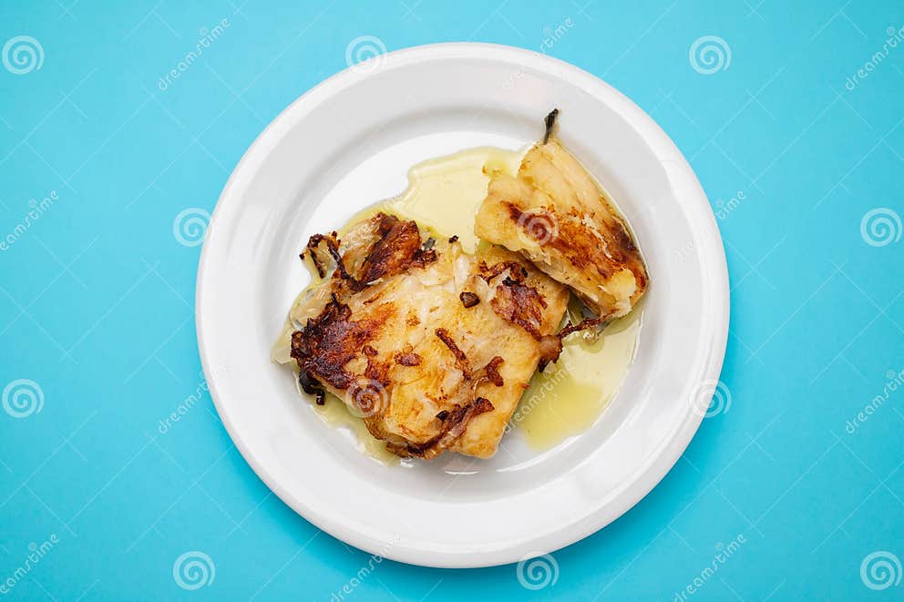 Fried Cod Fish with Olive Oil on White Dish Stock Photo - Image of ...