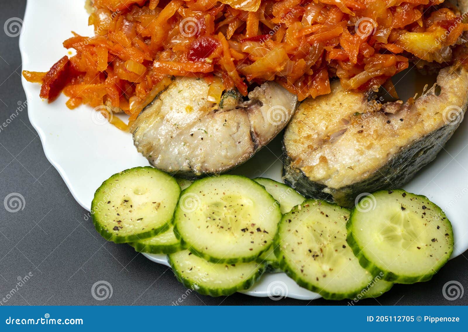 Top View of Fried Cod Fish Slices, Fresh Cucumbers and Stewed Onion ...