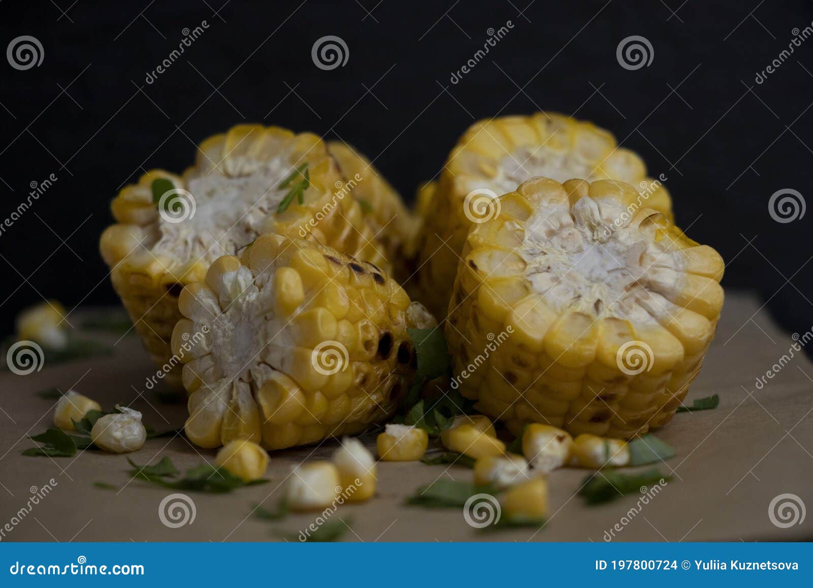 Fried Corn on Parchment Paper with Fine Herbs and Butter. Black ...