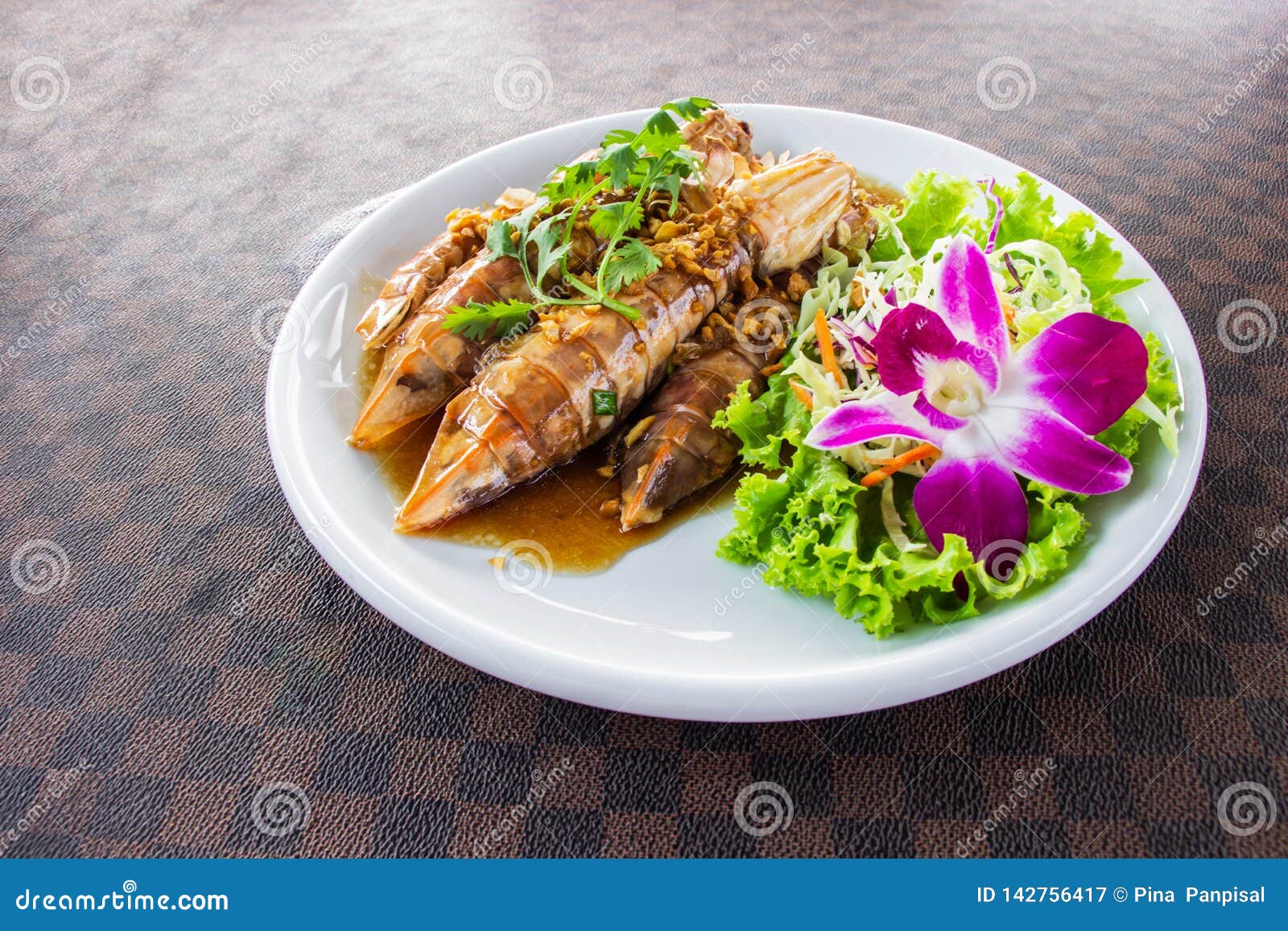 Fried Crayfish with Garlic Decorated with Purple Orchid on a White ...