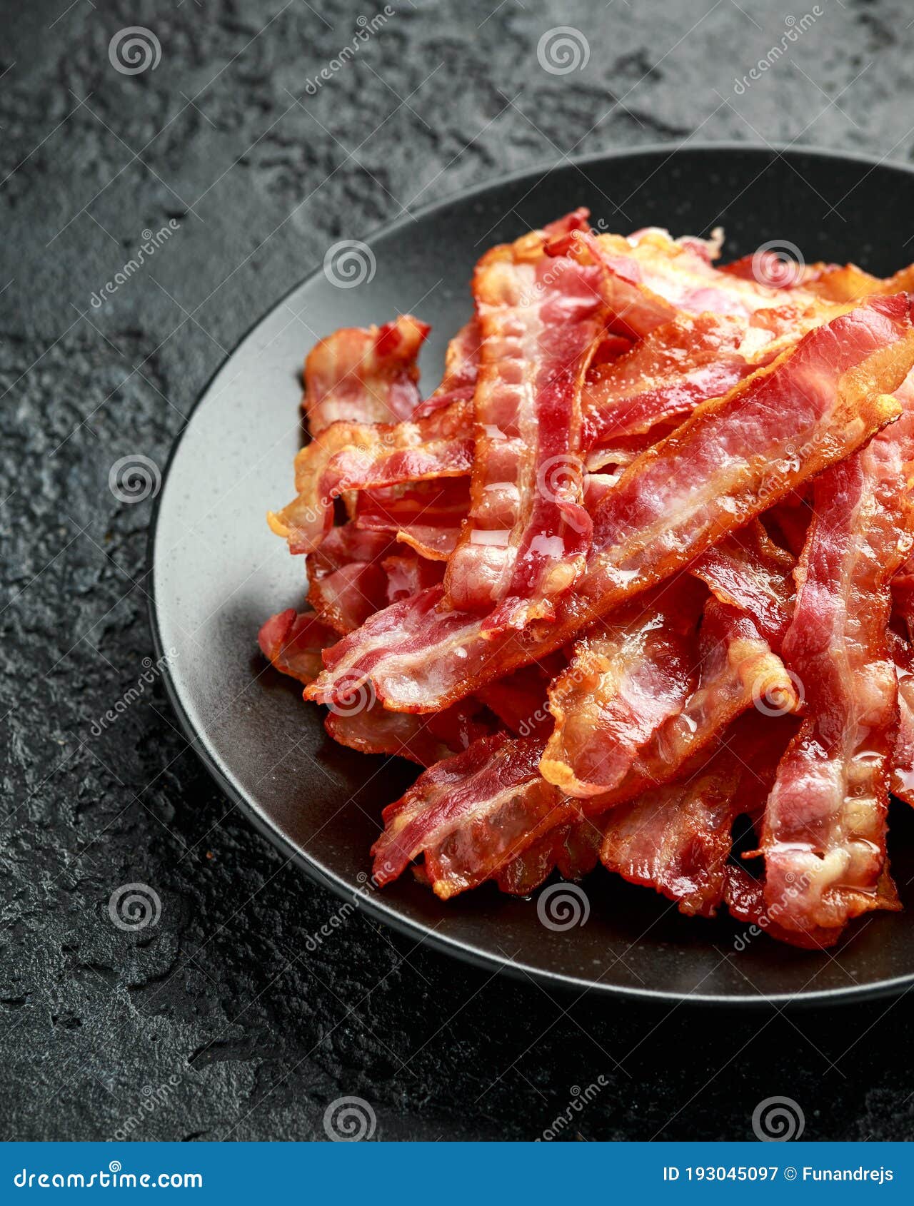 Fried Crunchy Streaky Bacon Pieces in a Black Plate Stock Image - Image ...