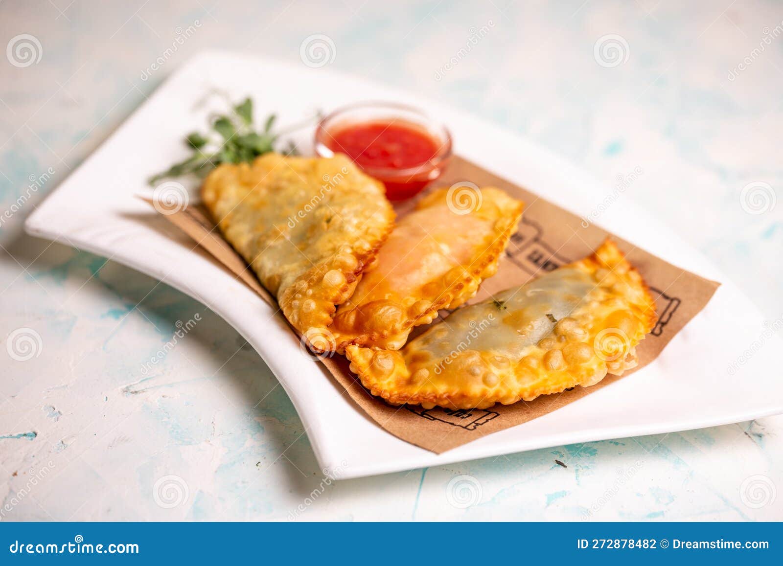 Fried Delicious Chebureks with Sauce on a White Plate Stock Photo ...