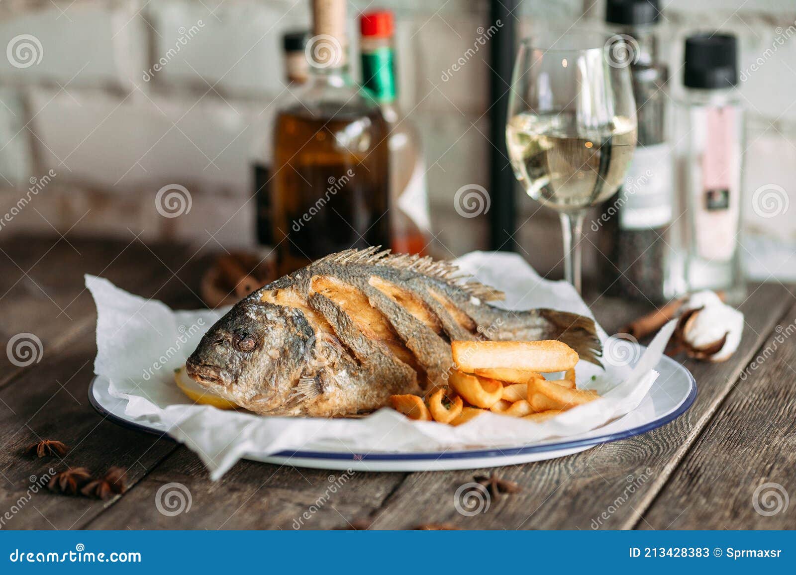 Fried Dorado Fish with Fries Chips and White Wine Stock Image - Image ...