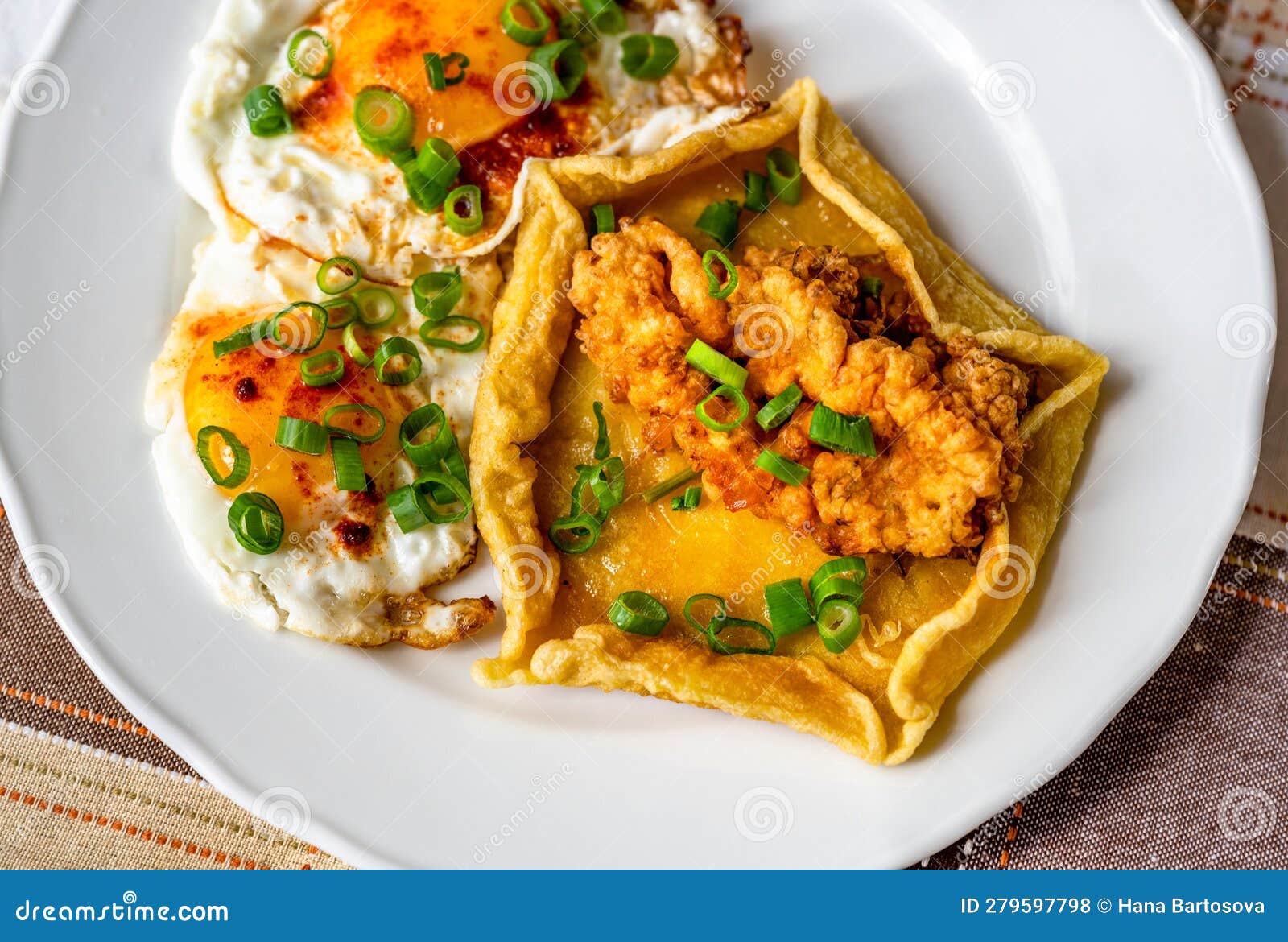 Fried Egg and Salty Pancake with Fried Elderflower on White Plate Stock ...