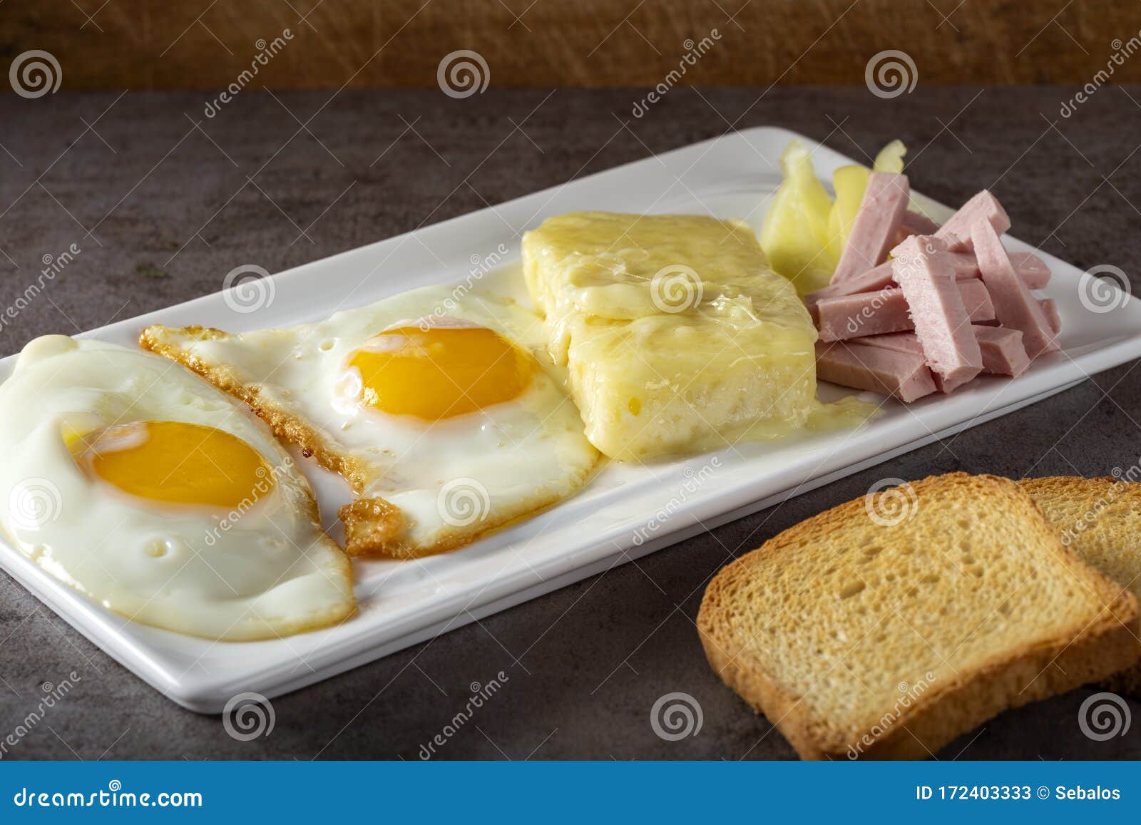 Fried Eggs with Melted Romanian Cheese Called Cas and Some Parizer ...