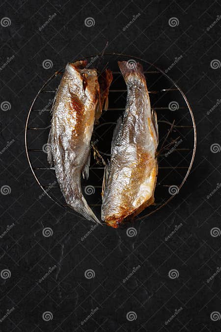 Fried Fish on the Black Table Stock Photo - Image of kitchen, lubina ...