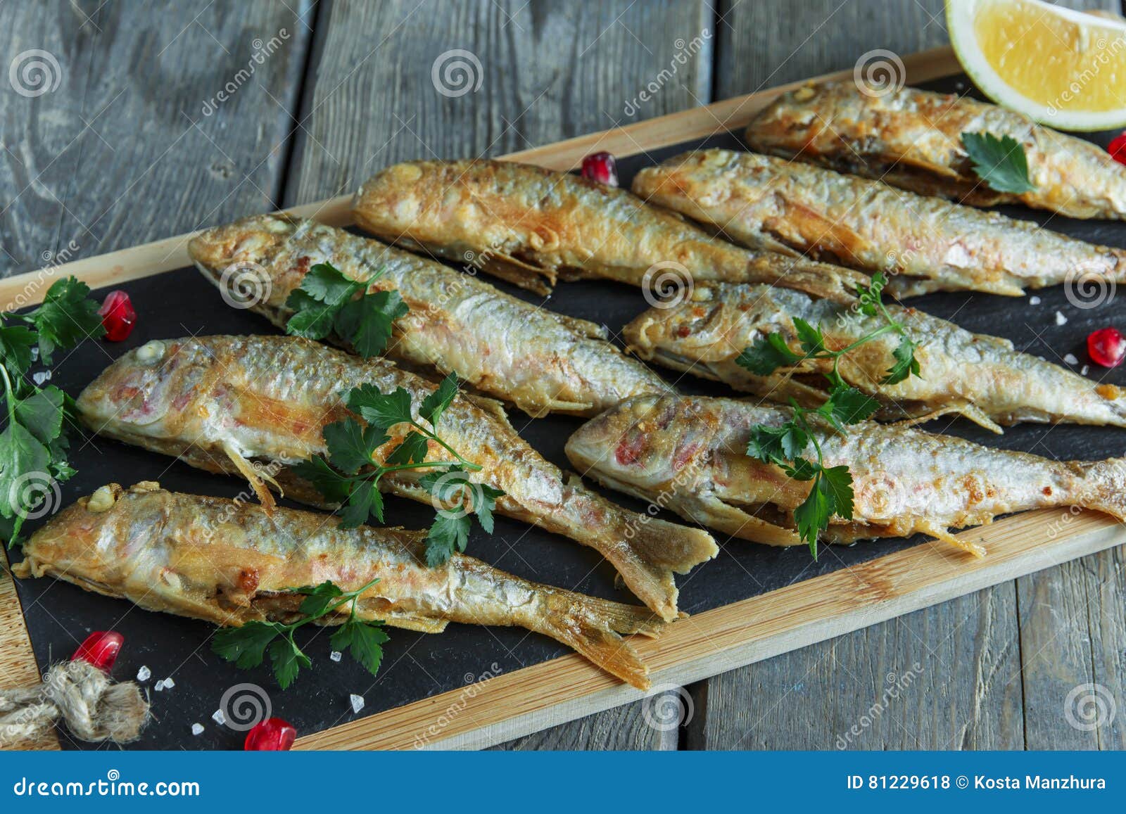Fried Fish Goatfish Surmullet with Lemon on Board Stock Photo - Image ...