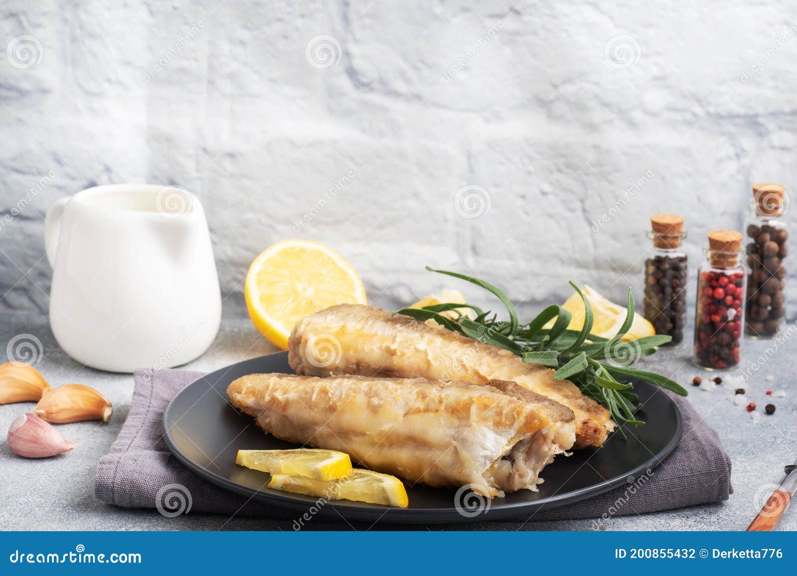 Fried Fish Hake Pollock and Slices of Fresh Lemon. Grey Concrete ...