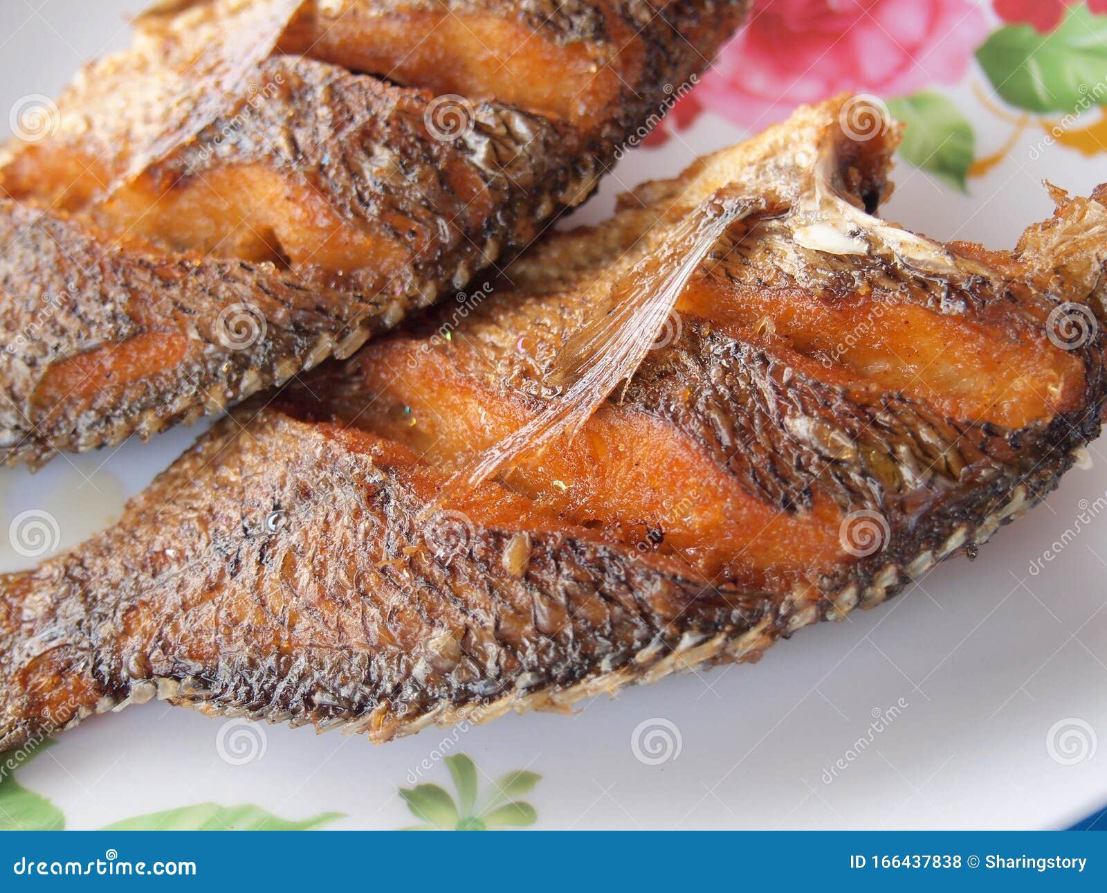 Fried fish on plate stock photo. Image of roasted, dinner - 166437838