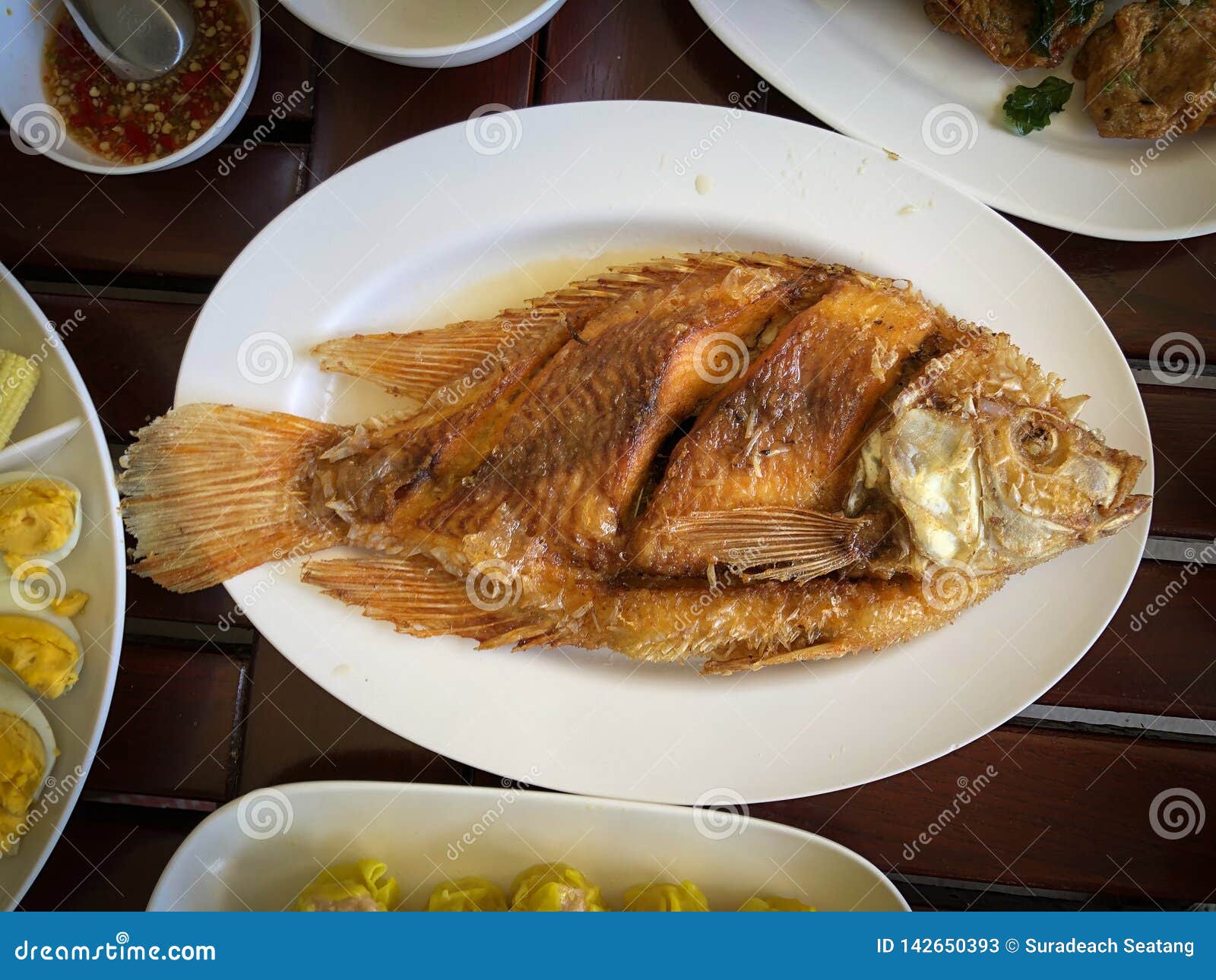 Fried fish in plate stock image. Image of delicious - 142650393