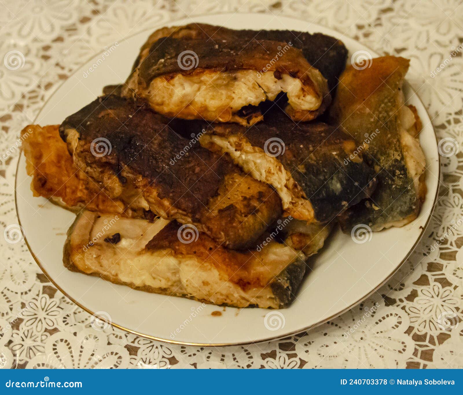 Fried fish on a plate stock photo. Image of plate, cooking - 240703378