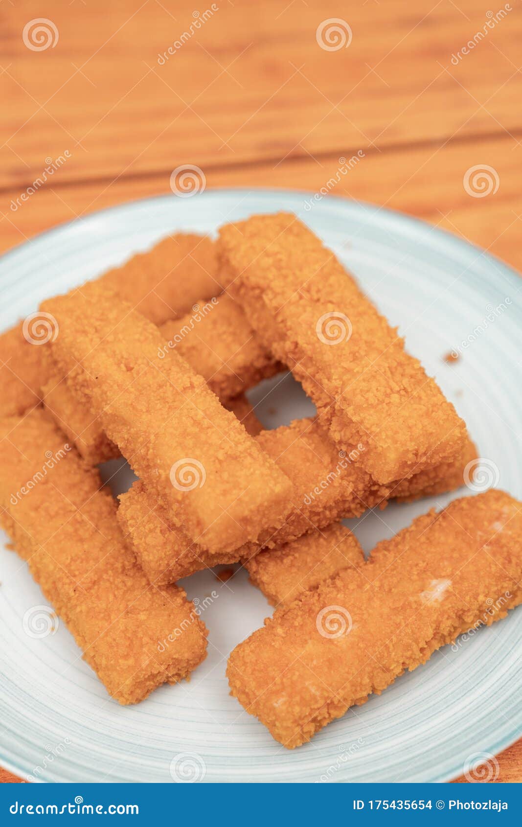 Fried Fish Sticks on the Plate Above Wooden Background Stock Photo ...