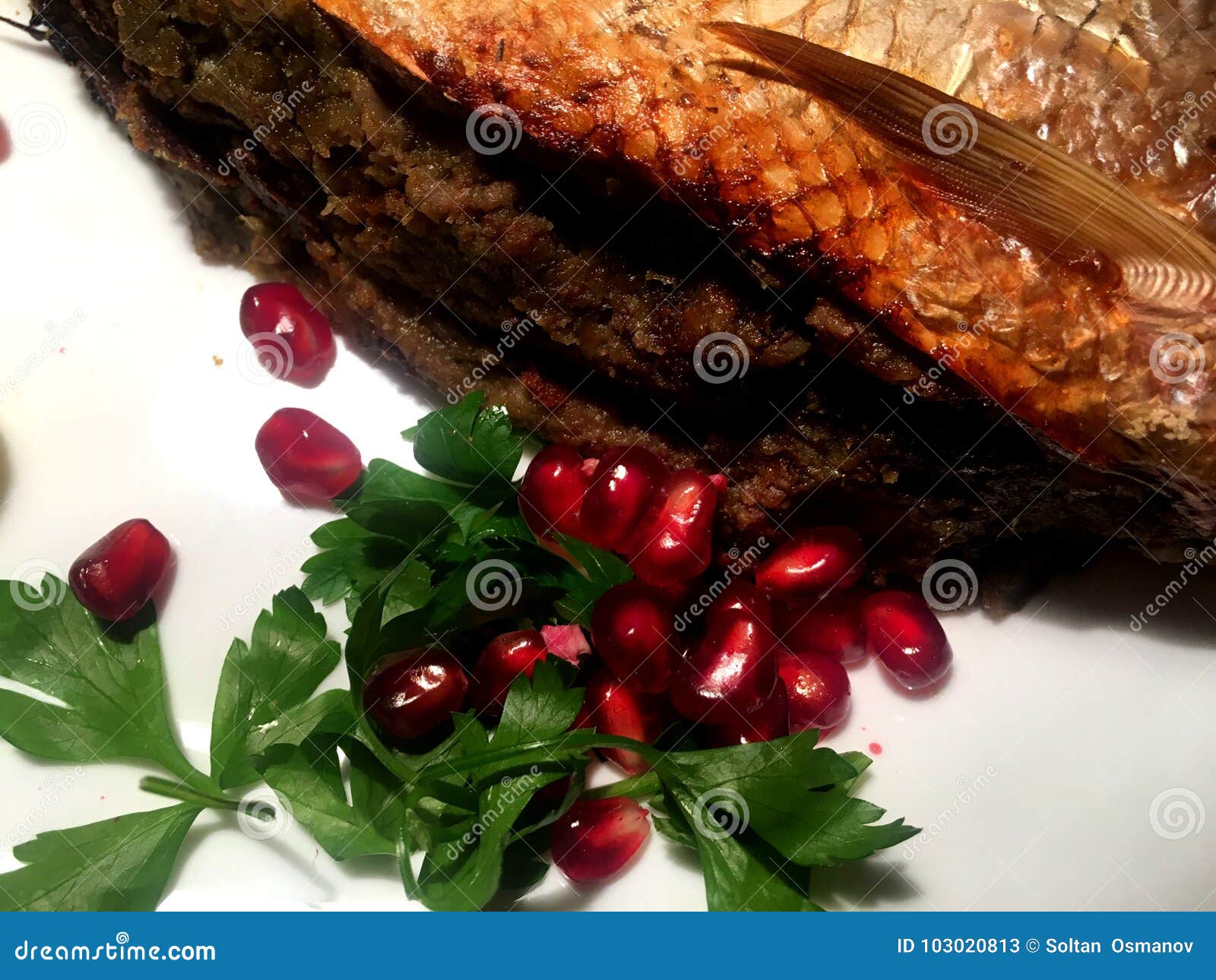 Fried Fish with a Stuffing. Pomegranate and Lemon Stock Image - Image ...