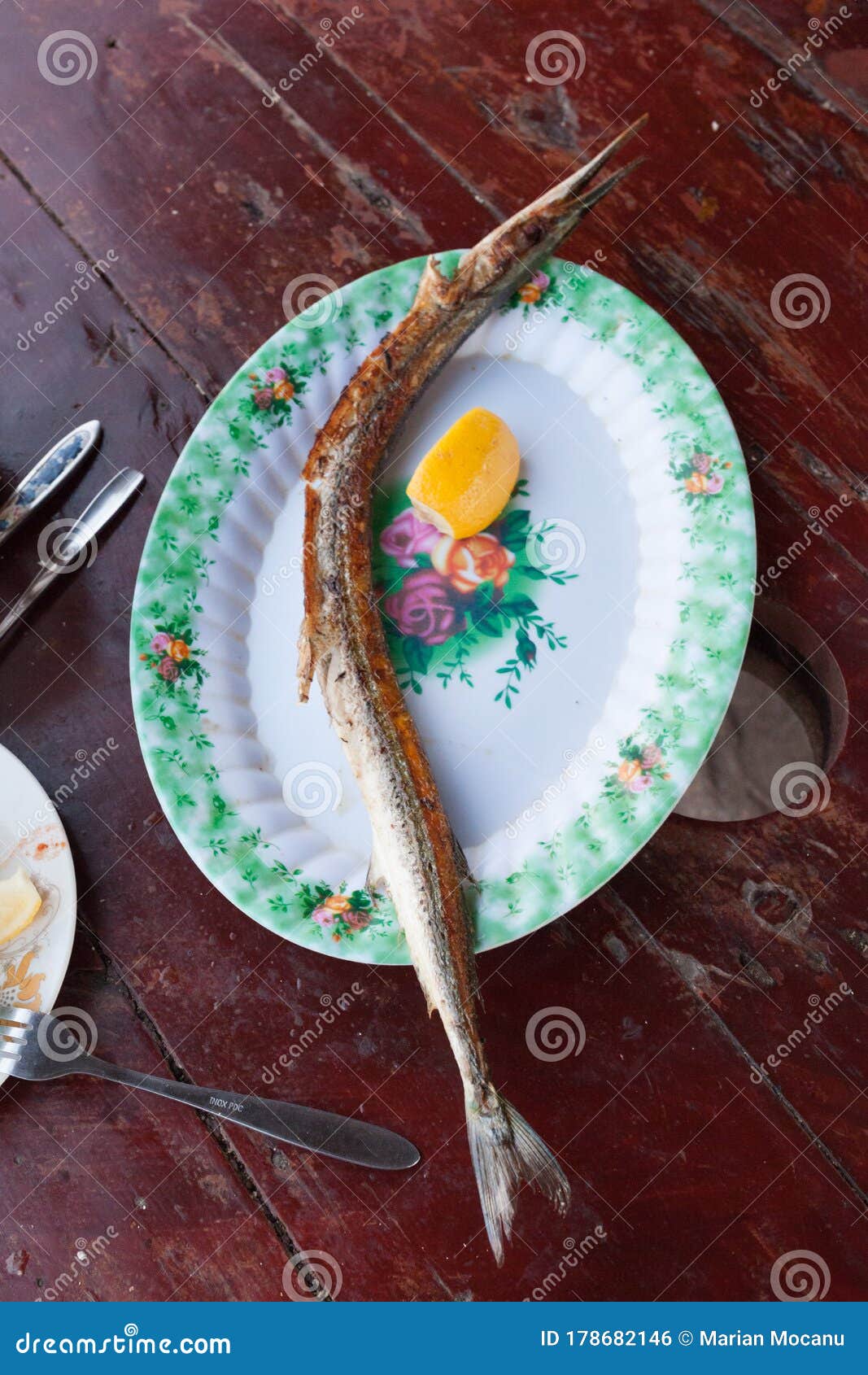 Fried Garfish in a Plate on the Table with Lemon Stock Photo - Image of ...