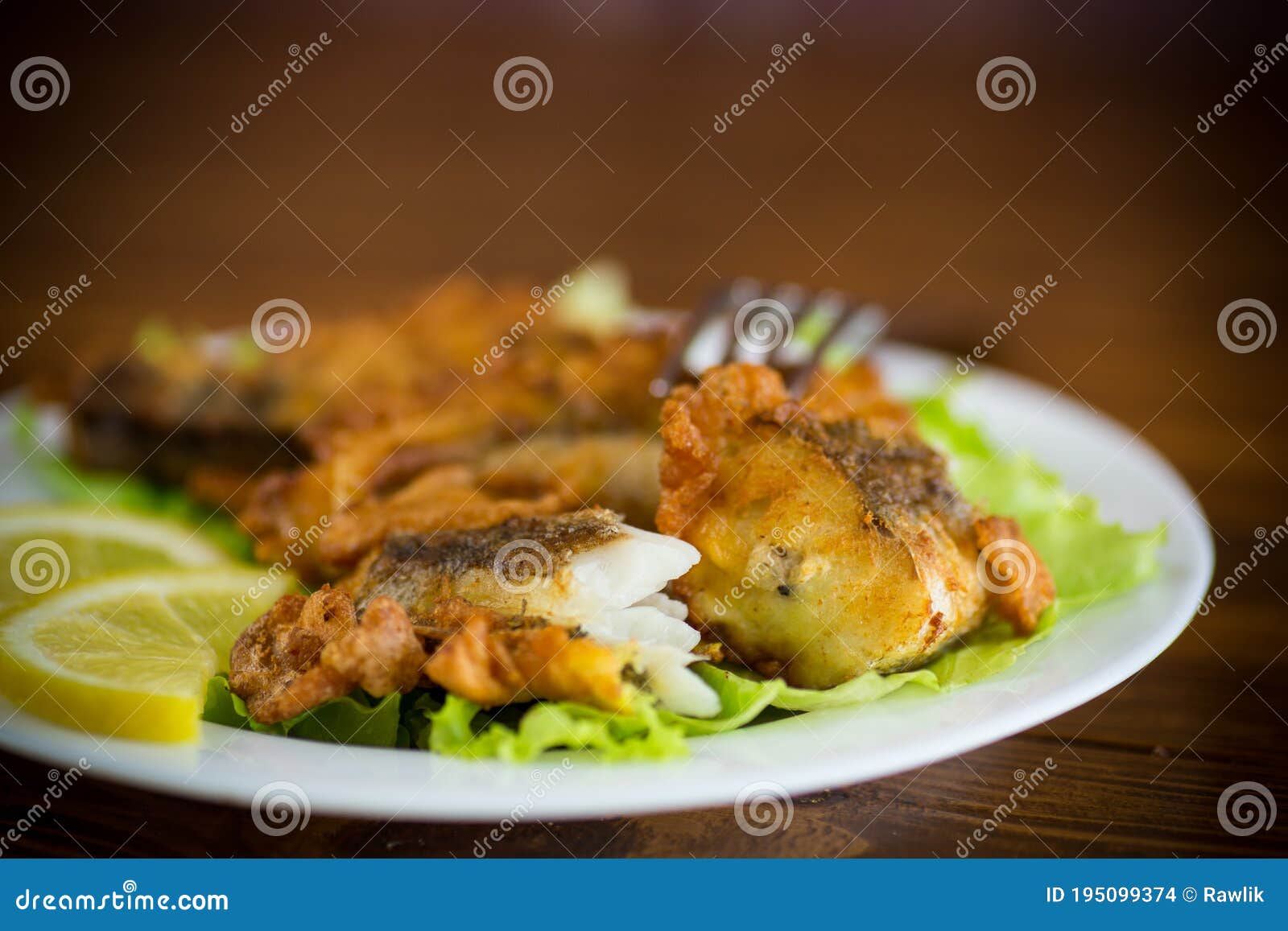Fried Hake Fish in Batter with Lettuce and Lemon in a Plate Stock Photo ...